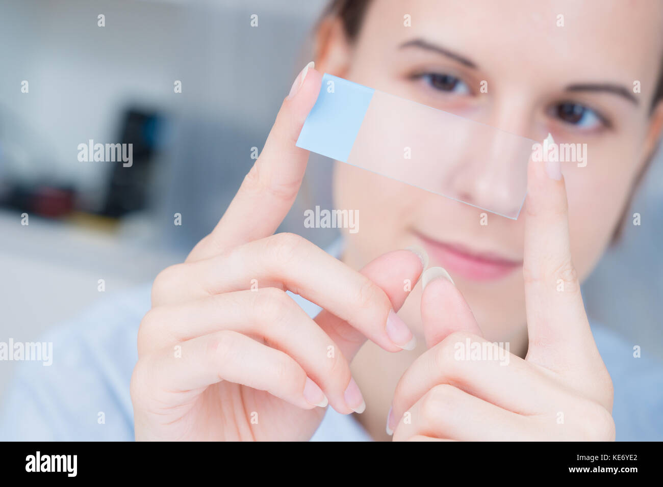 student girl with glass empty microscope slide in hand Stock Photo - Alamy