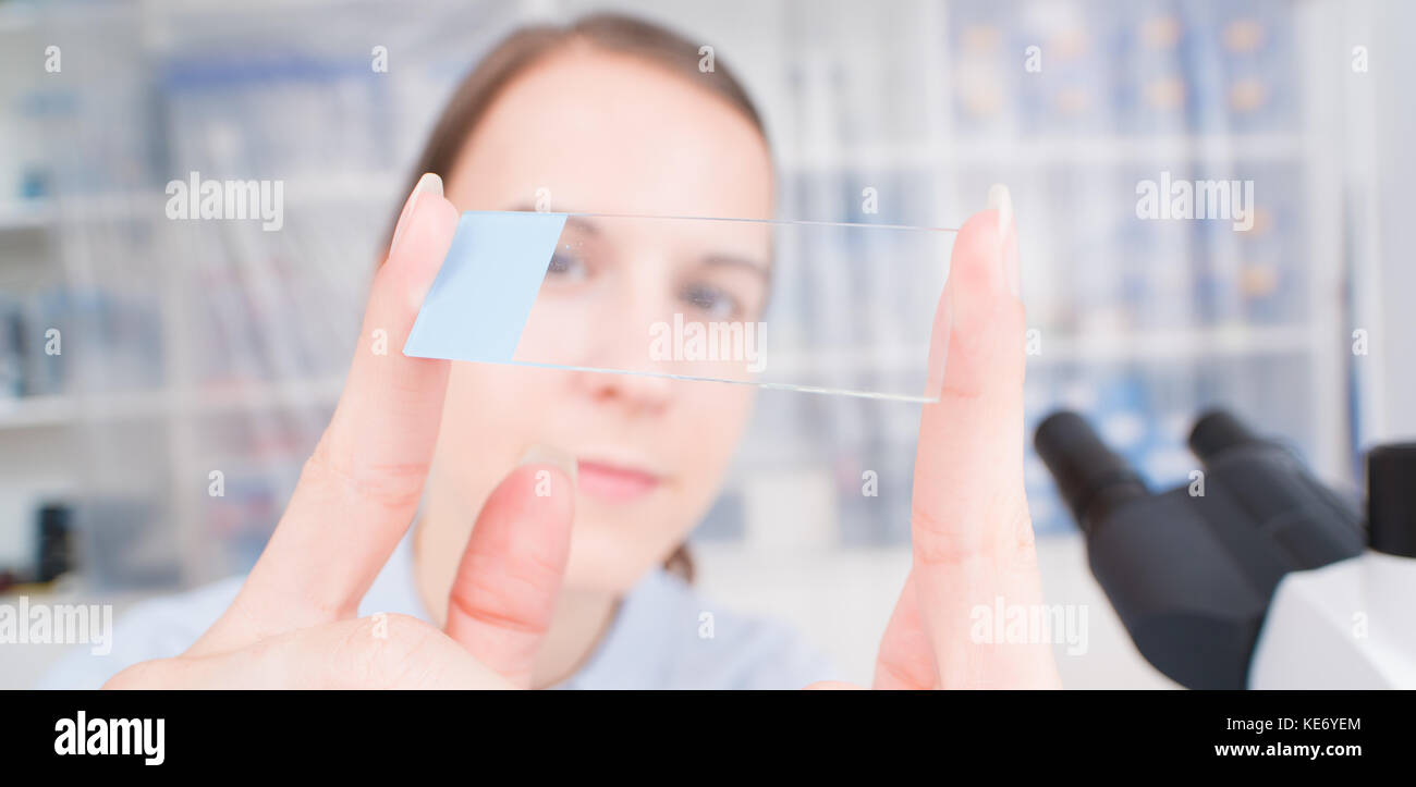 young woman scientific / female student researcher looking microscope ...