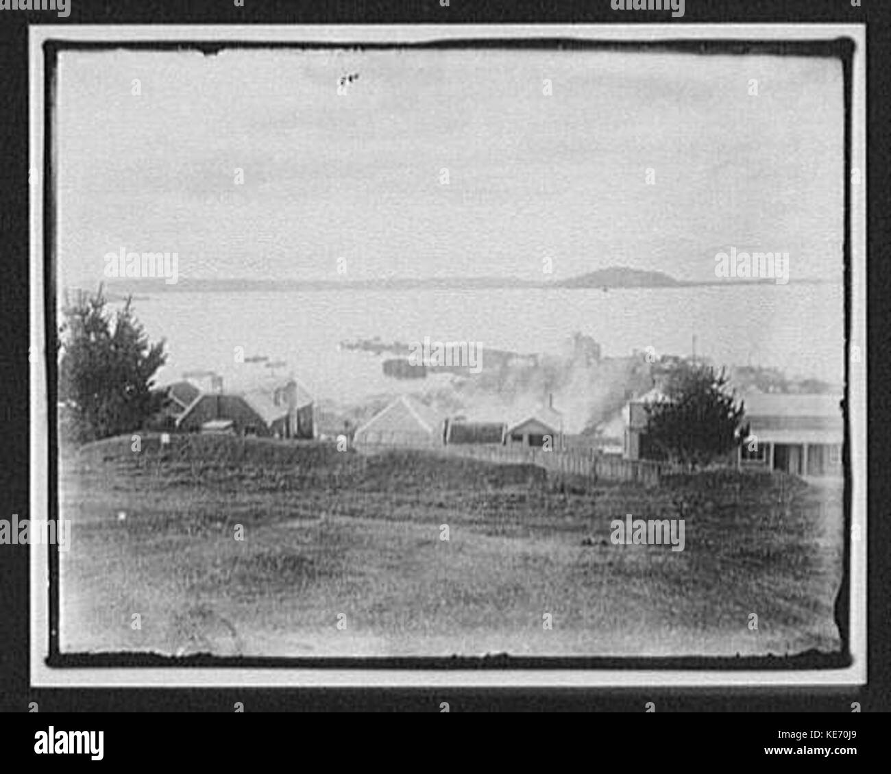 This view captures a coastal town, possibly from a historical period ...