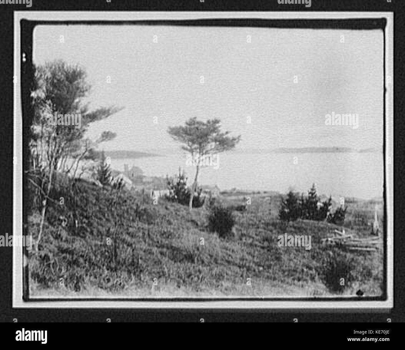 A scenic view of a coastal town, captured in a historical photograph ...