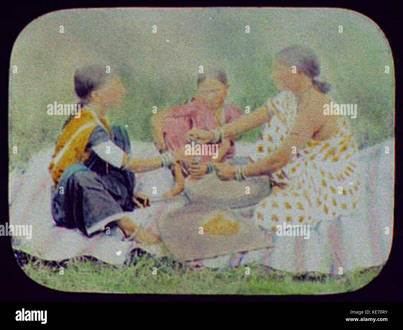 Three women grinding food on flat stones LCCN2004707708 Stock Photo - Alamy