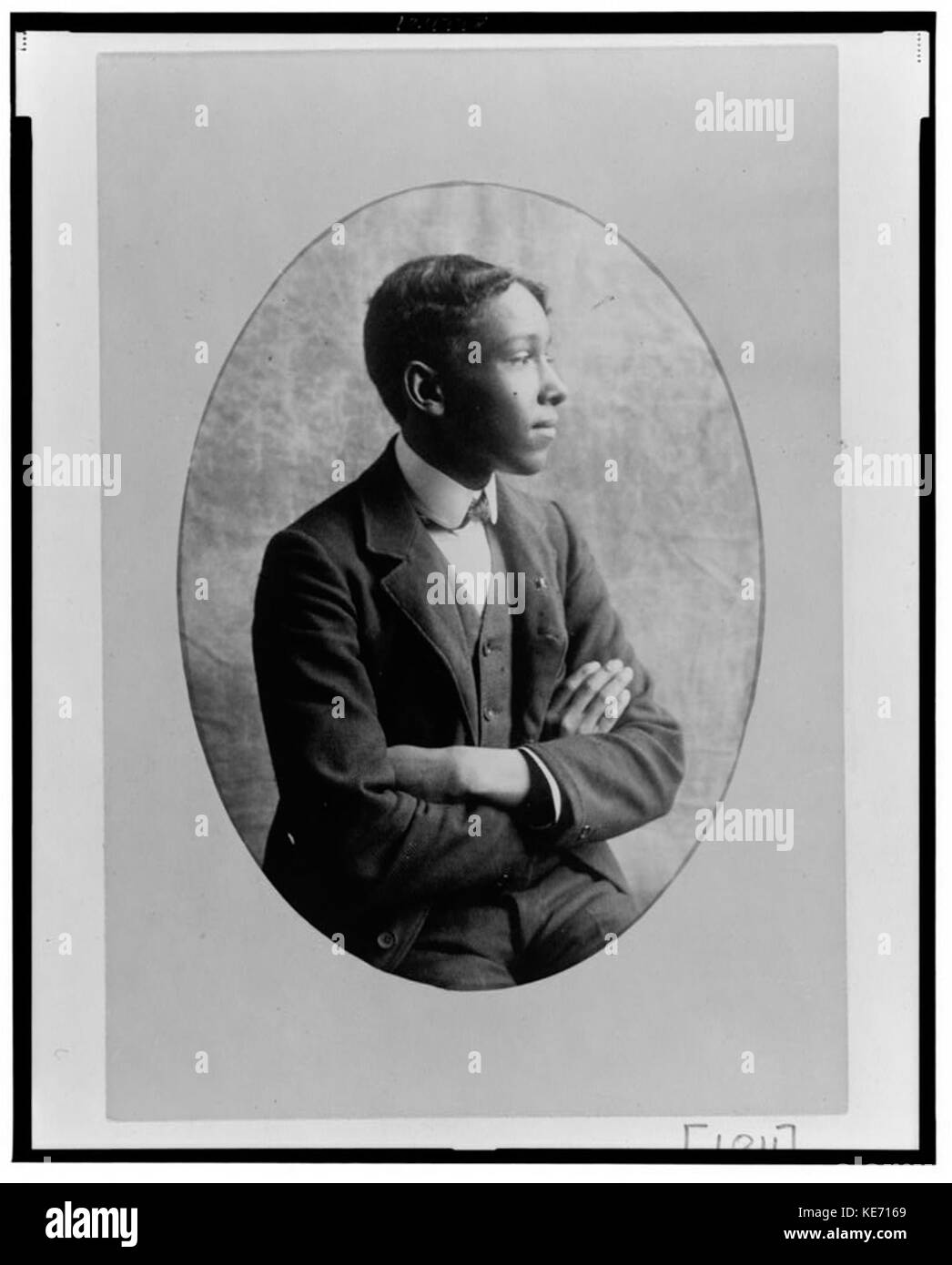 Young African American man, half length portrait, seated with arms ...