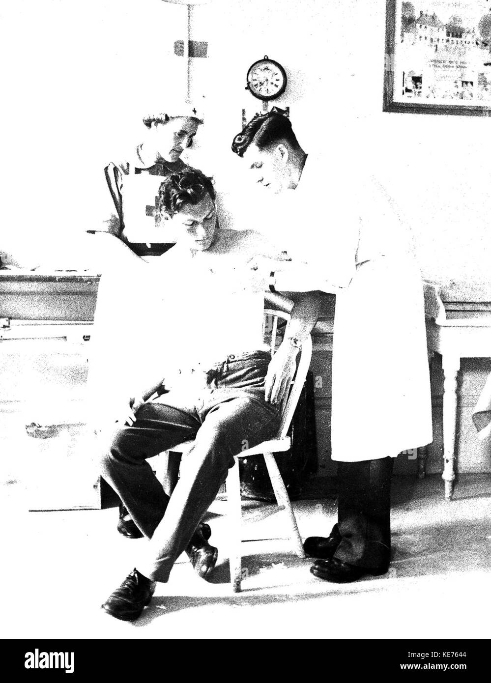 Doctor treating Black and White Stock Photos & Images - Alamy