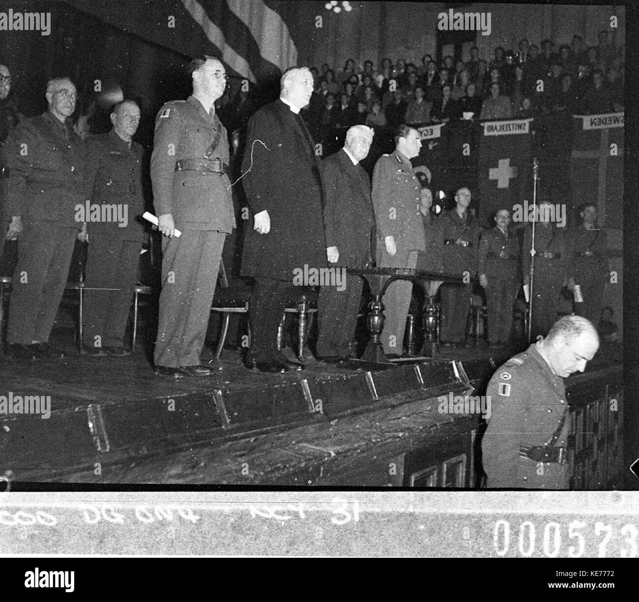 This photograph captures Archbishop Mowll and army officers attending a ...