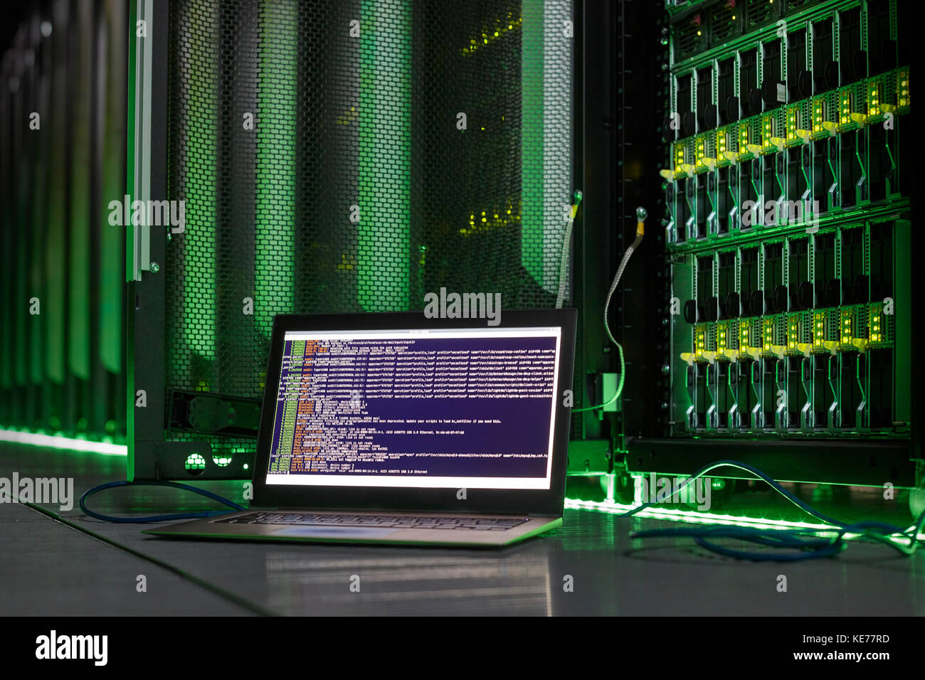 Laptop with computer language in server room Stock Photo - Alamy