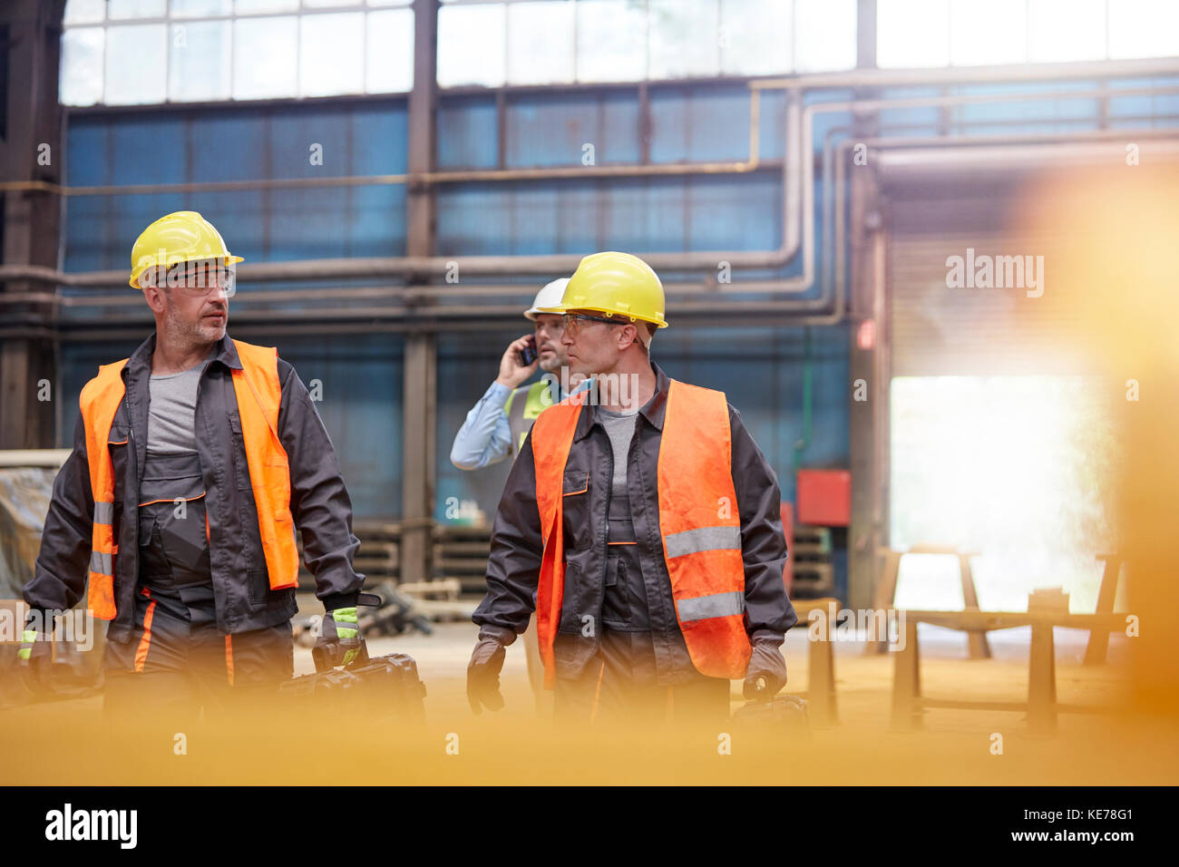 Male workers walking in factory Stock Photo - Alamy