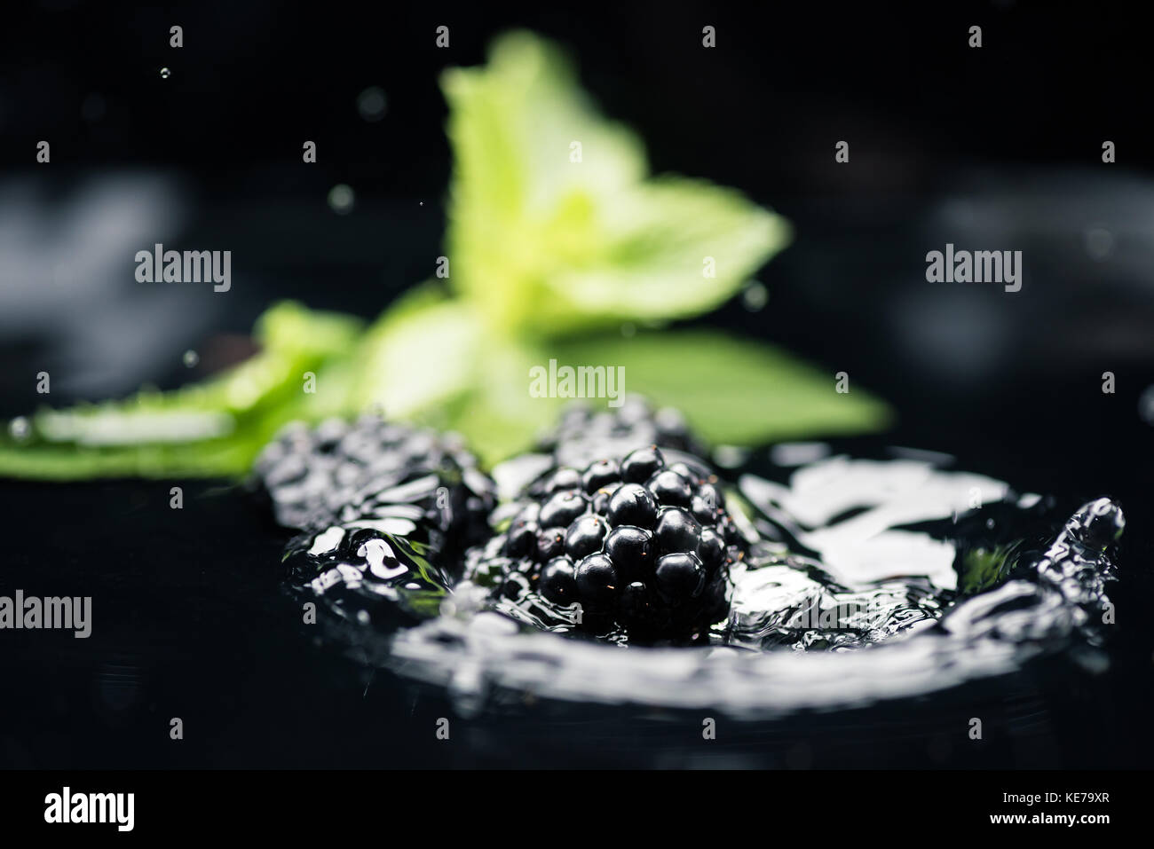 ripe blackberries falling in water Stock Photo - Alamy