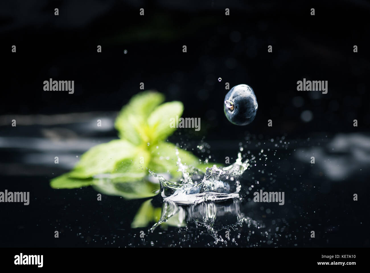ripe blueberry falling in water Stock Photo - Alamy