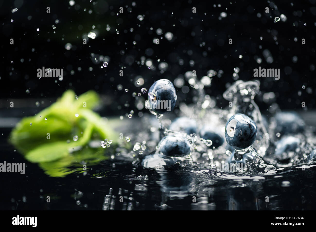 ripe blueberries dropping in water Stock Photo - Alamy