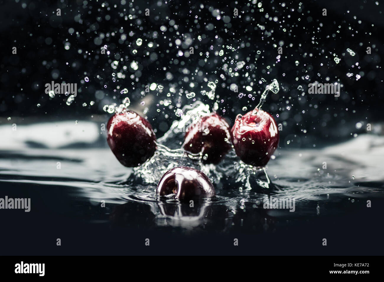 ripe cherries falling in water Stock Photo - Alamy