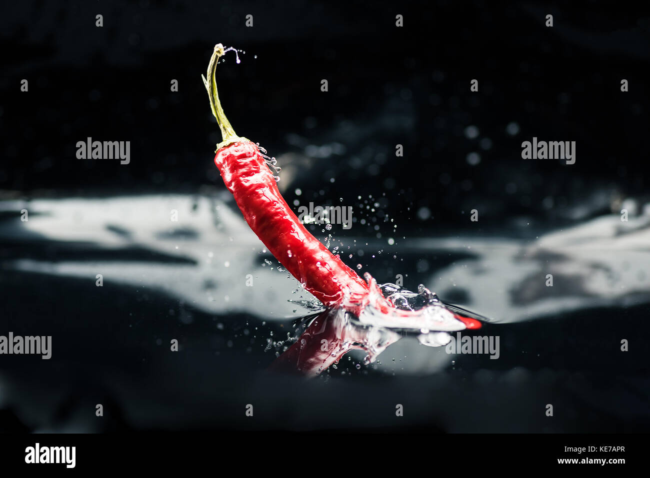 chili pepper falling in water Stock Photo - Alamy