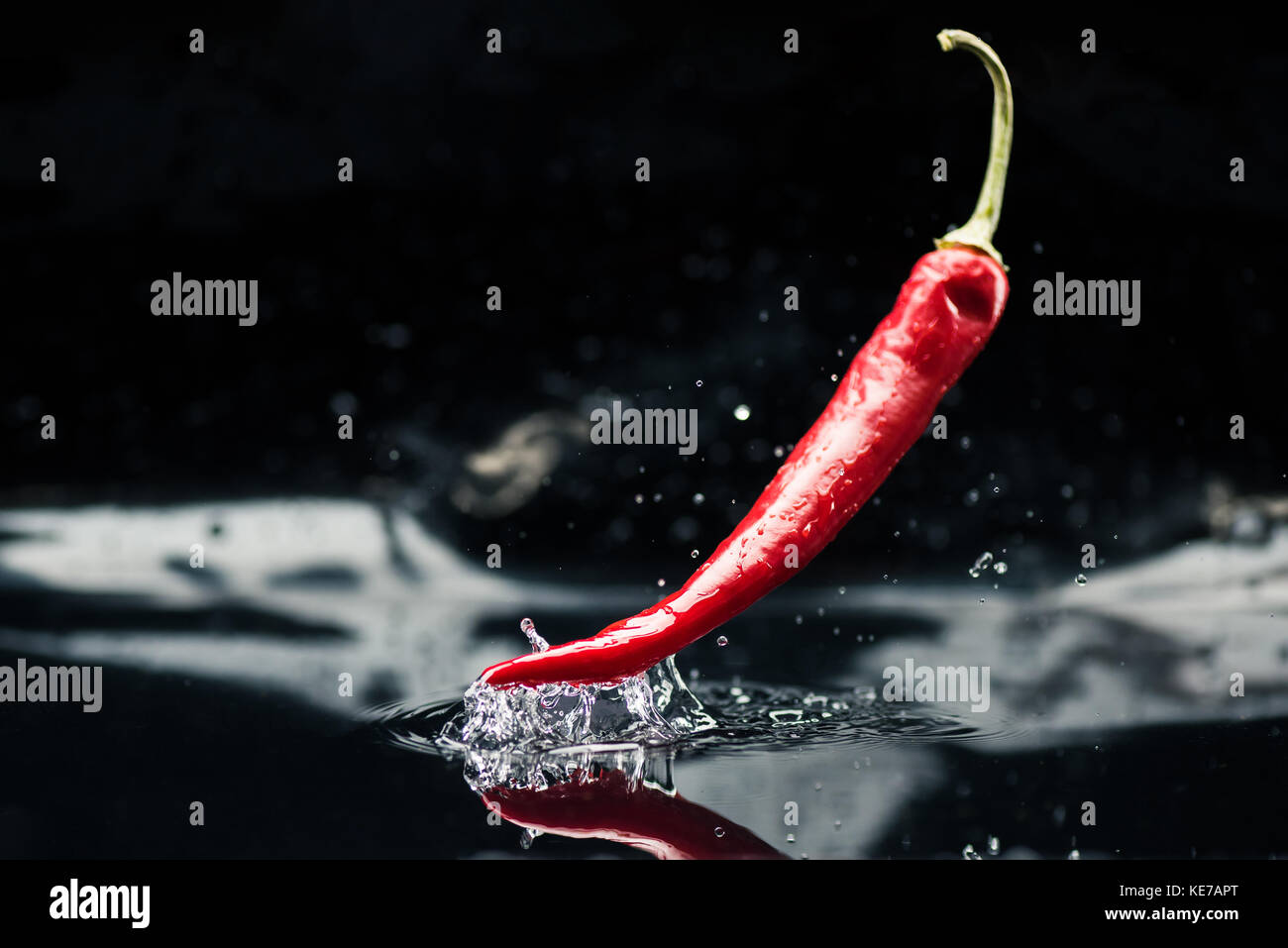 chili pepper falling in water Stock Photo - Alamy