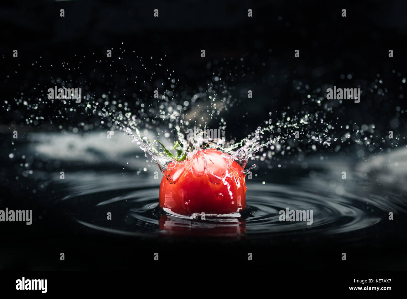 fresh tomato falling in water Stock Photo - Alamy
