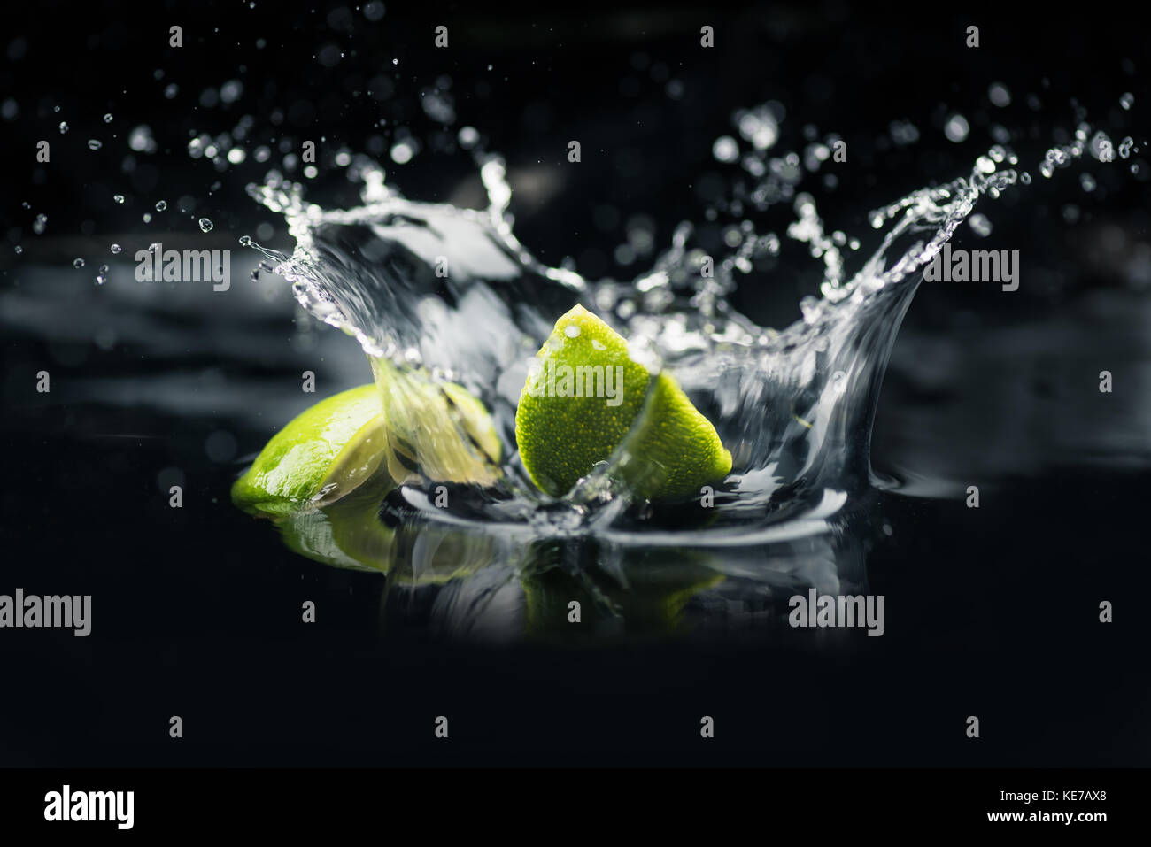 slices of lime falling in water Stock Photo - Alamy