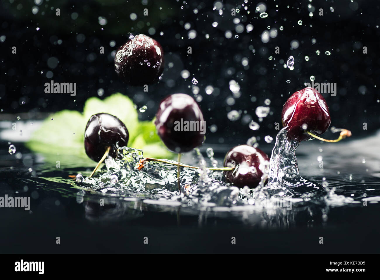 ripe cherries falling in water Stock Photo - Alamy