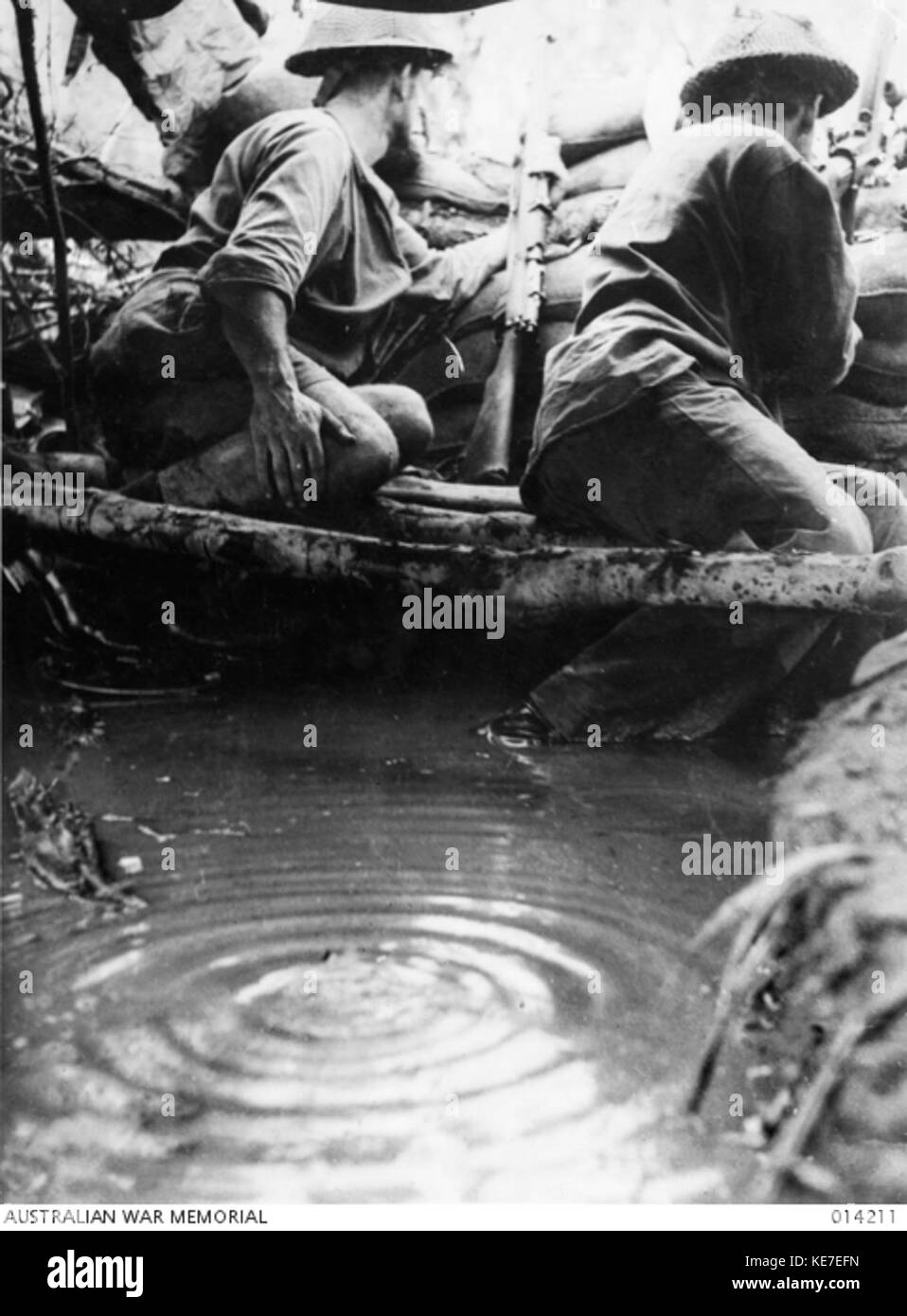 014211 Stand to in water filled pit Buna Stock Photo - Alamy