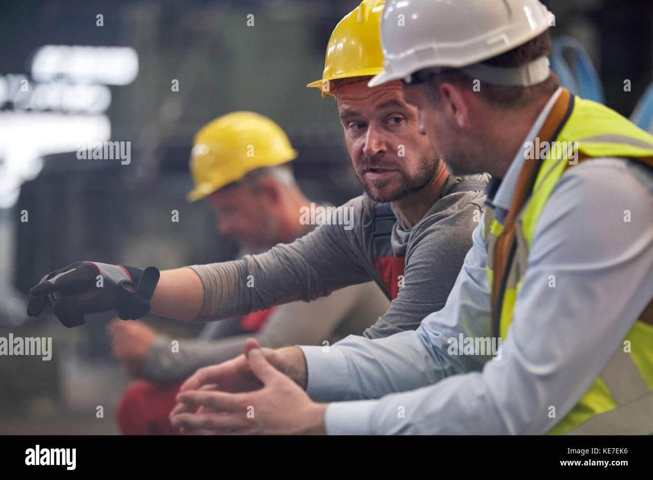 Male workers talking in factory Stock Photo - Alamy