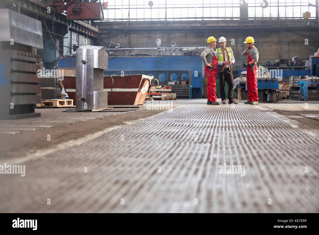 Male workers talking in factory Stock Photo - Alamy