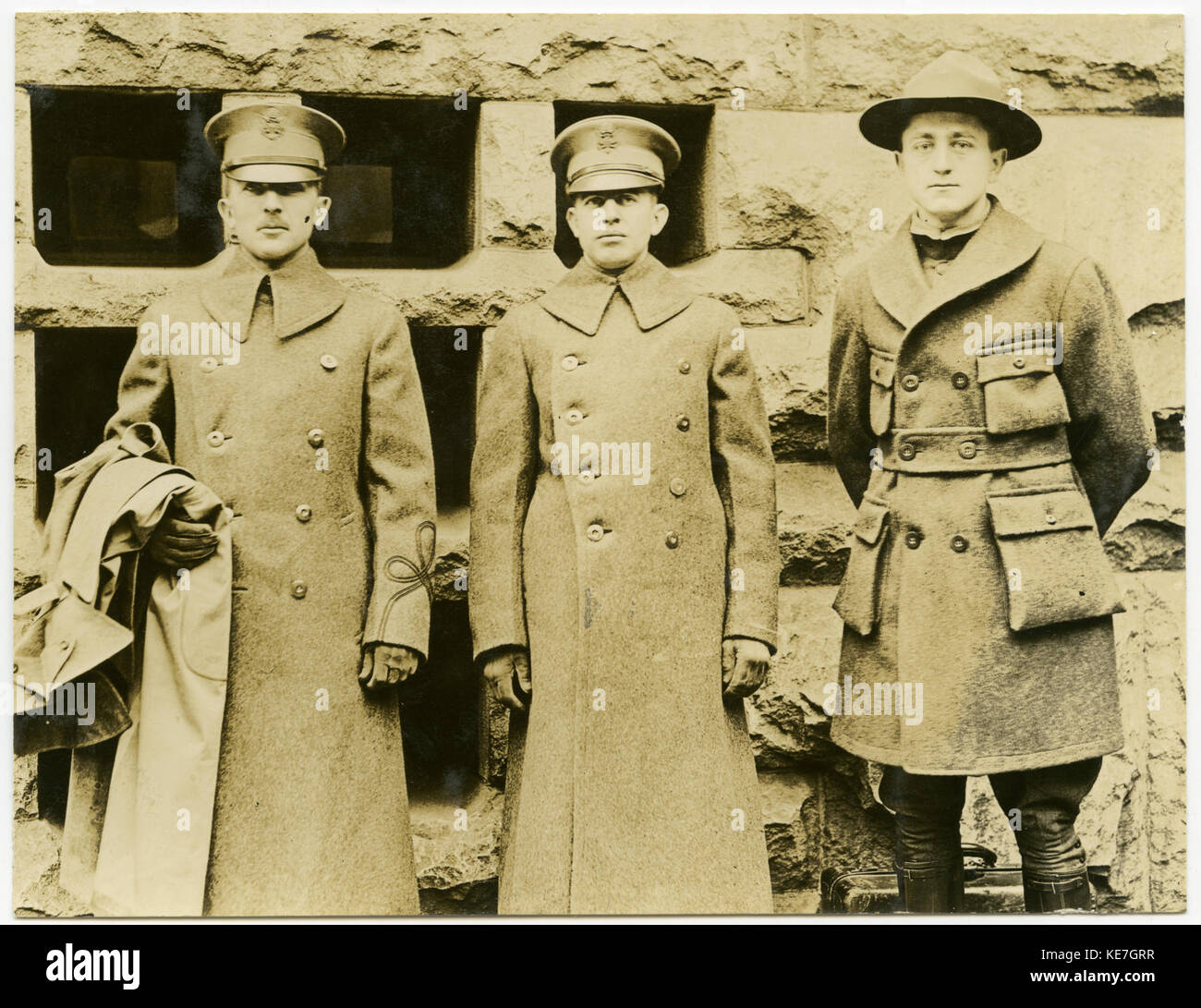 Three Soldiers Standing in Front of a Wall Posing for Picture Stock ...