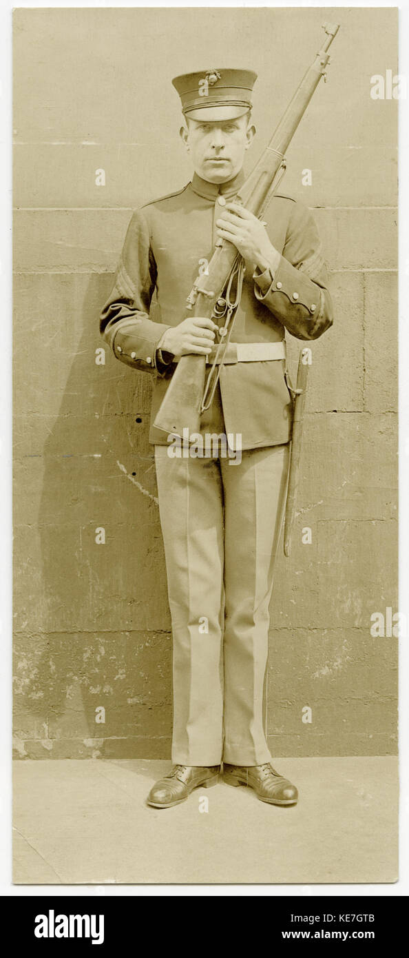 Uniformed Soldier Posing For a Picture in Front of a Concrete Wall ...