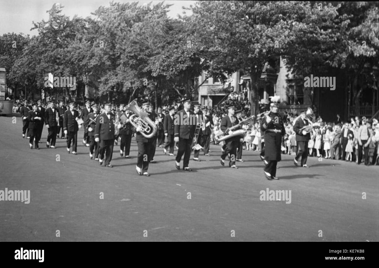 This image depicts a parade in honor of St. Jean Baptiste, likely in ...