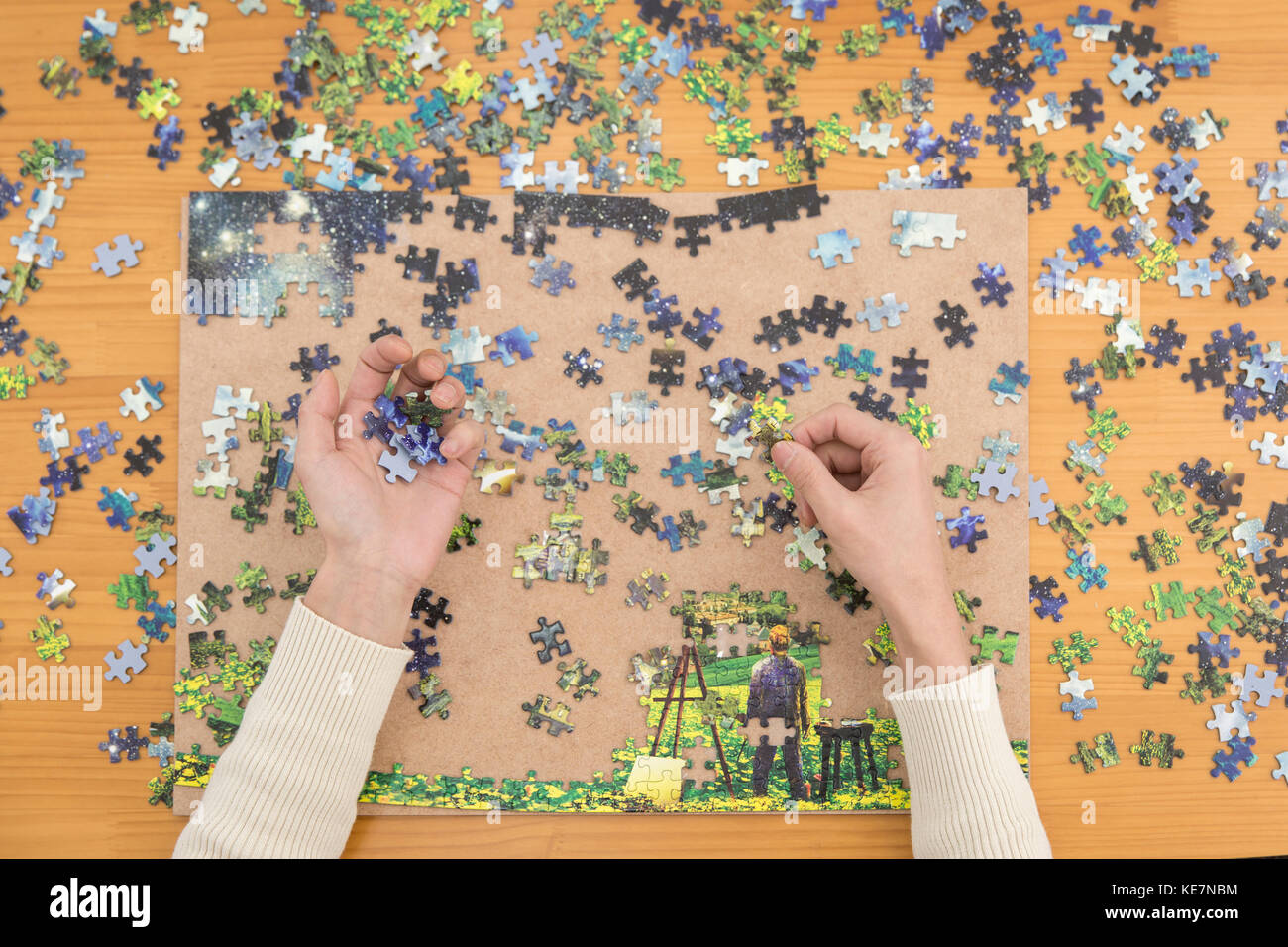 Hands doing puzzle Stock Photo - Alamy