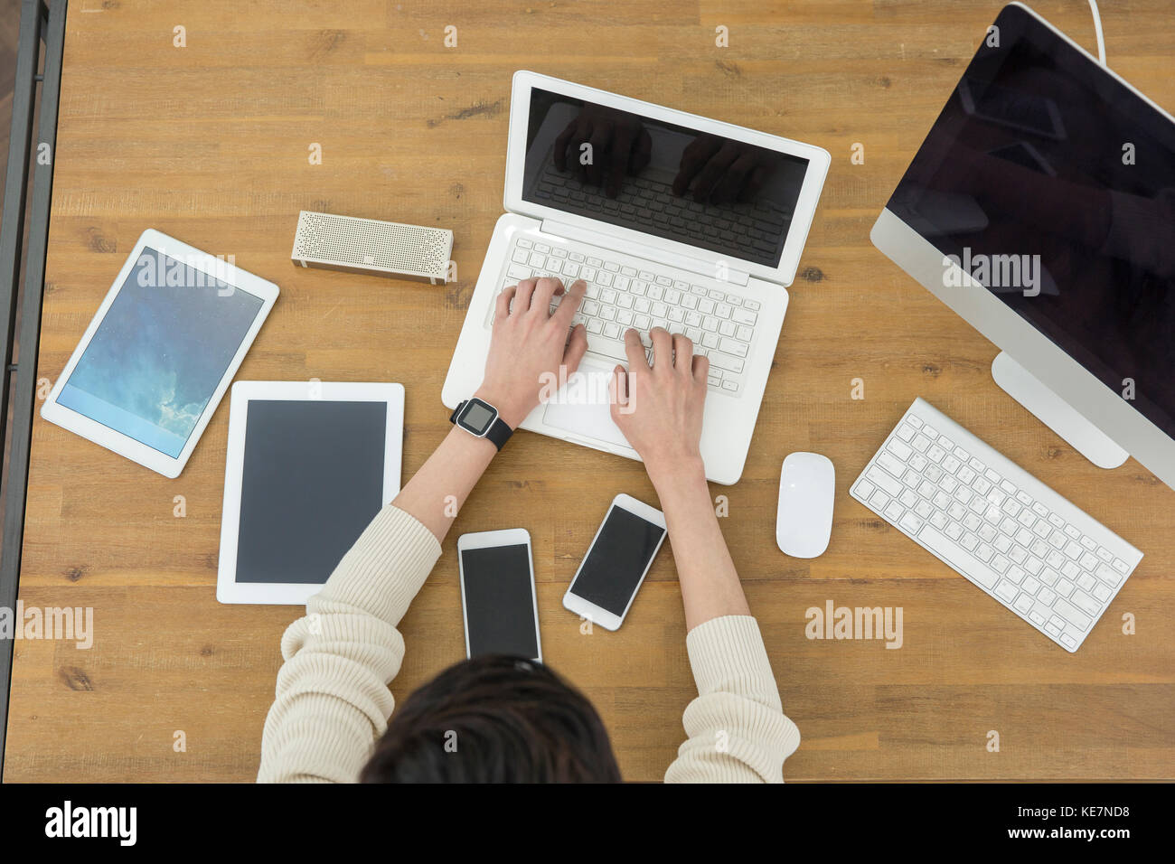Man using a notebook computer with various mobile equipments Stock ...