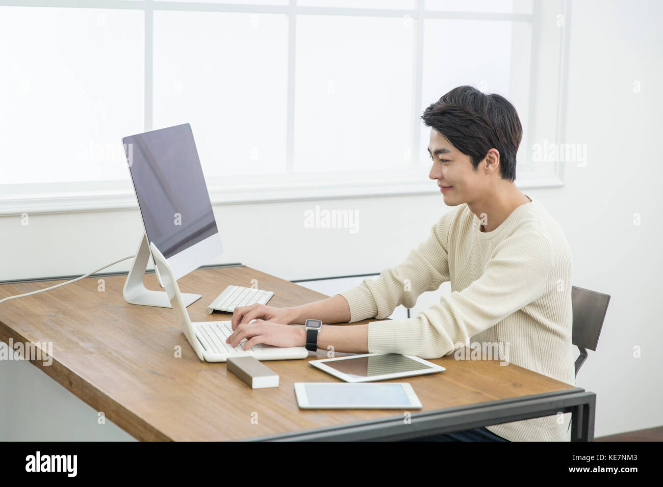 Side view portrait of smiling man using laptop Stock Photo - Alamy