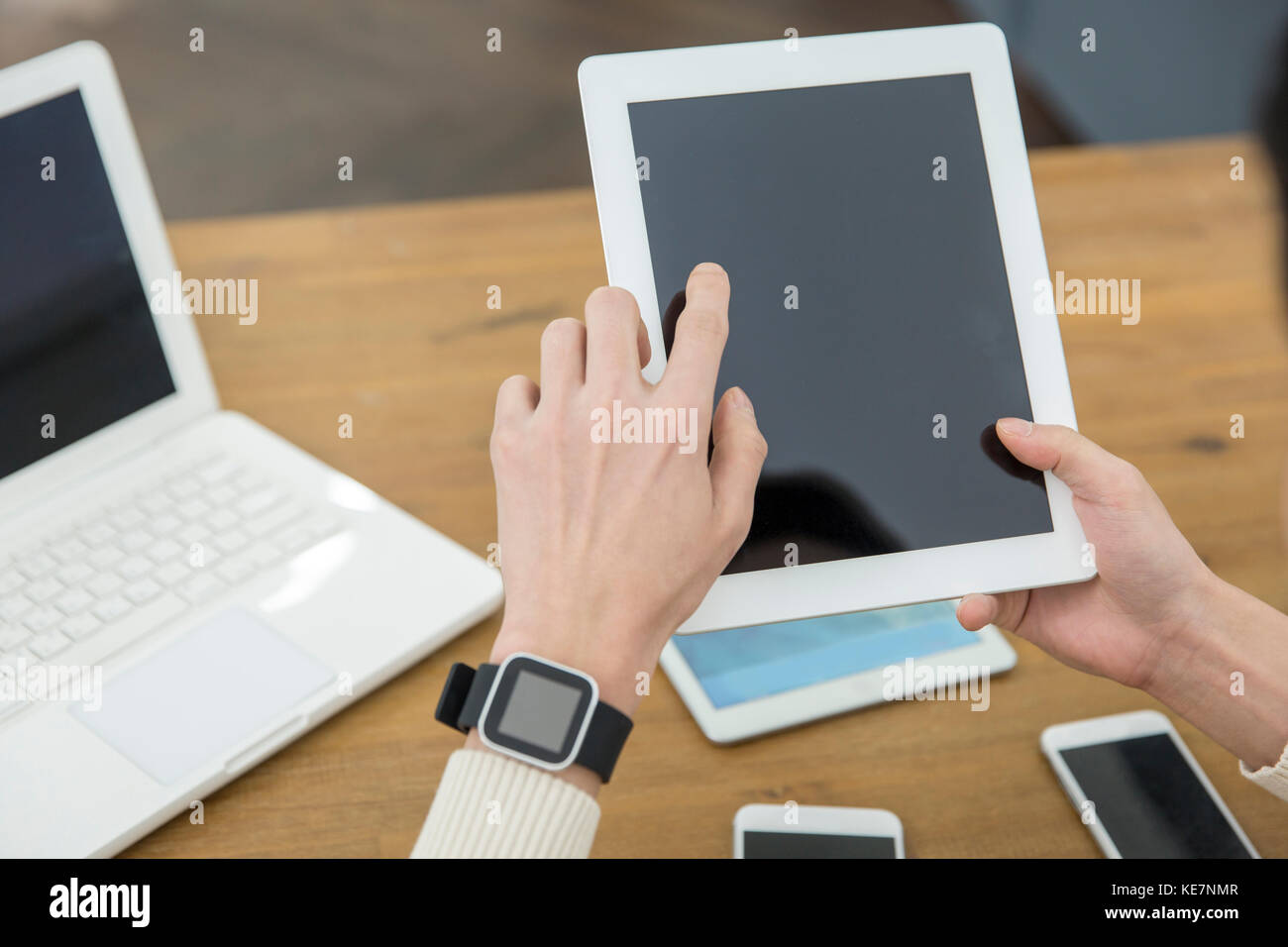 Hands holding and touching an electric tablet Stock Photo - Alamy