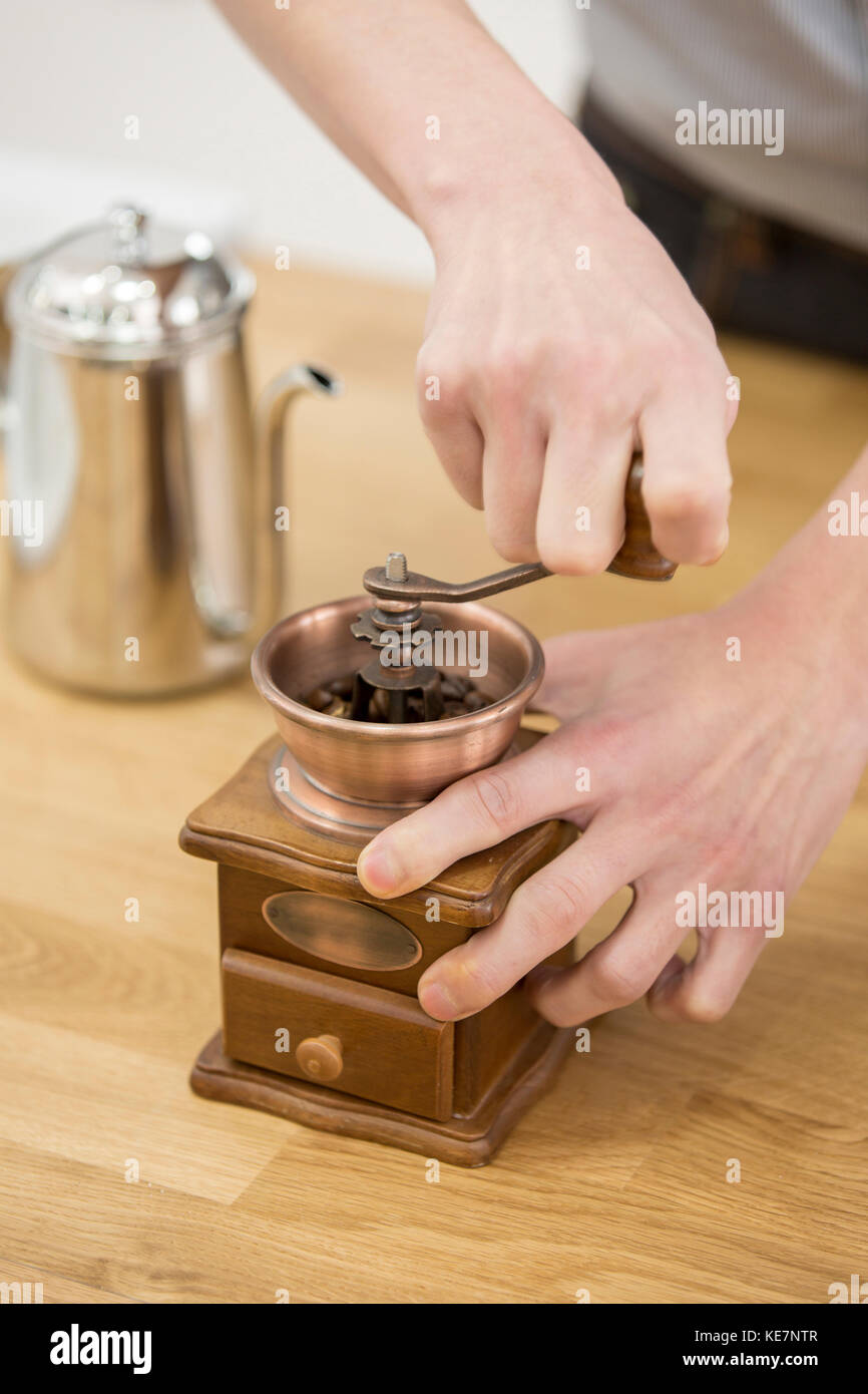 Man using a grinder in kitchen Stock Photo - Alamy