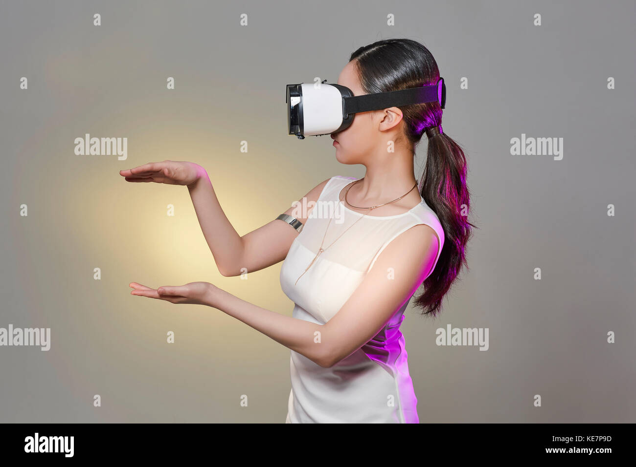 Side view of young woman wearing virtual reality headset Stock Photo ...