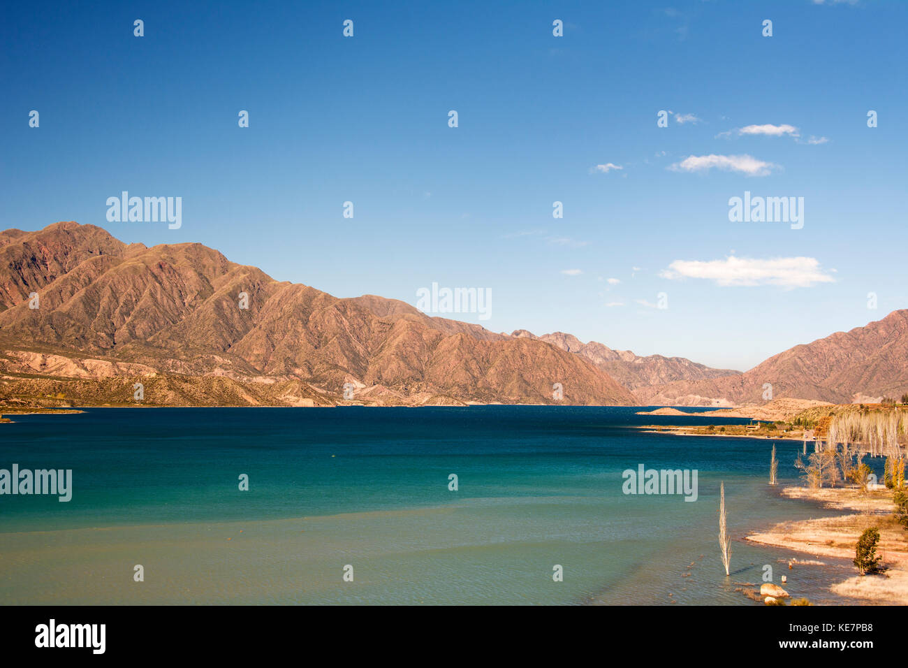 A Lake Surrounded By Colourful Desert Mountains; Potrerillos, Mendoza ...