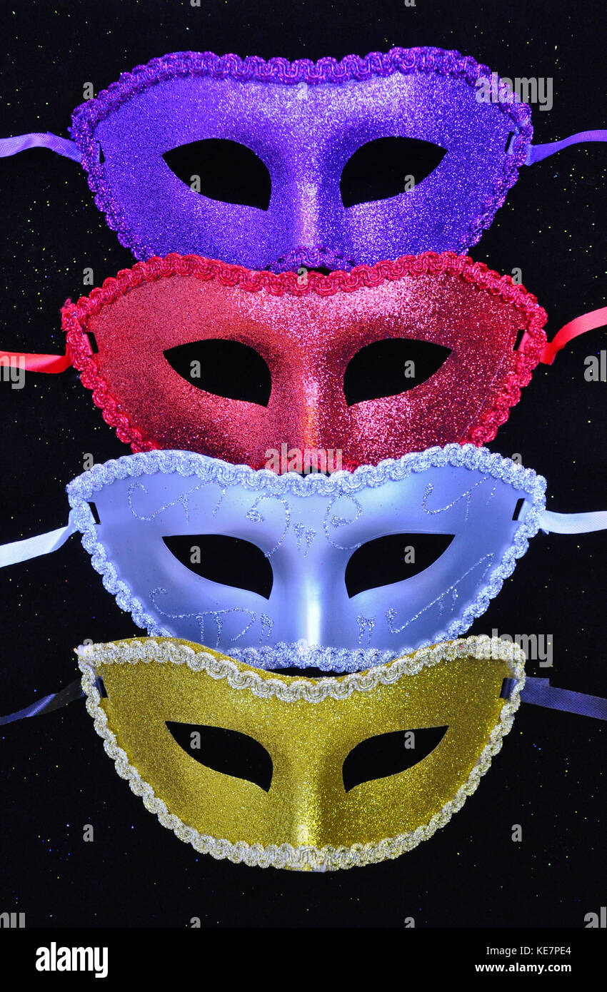 Colorful glitter masks on black background Stock Photo - Alamy