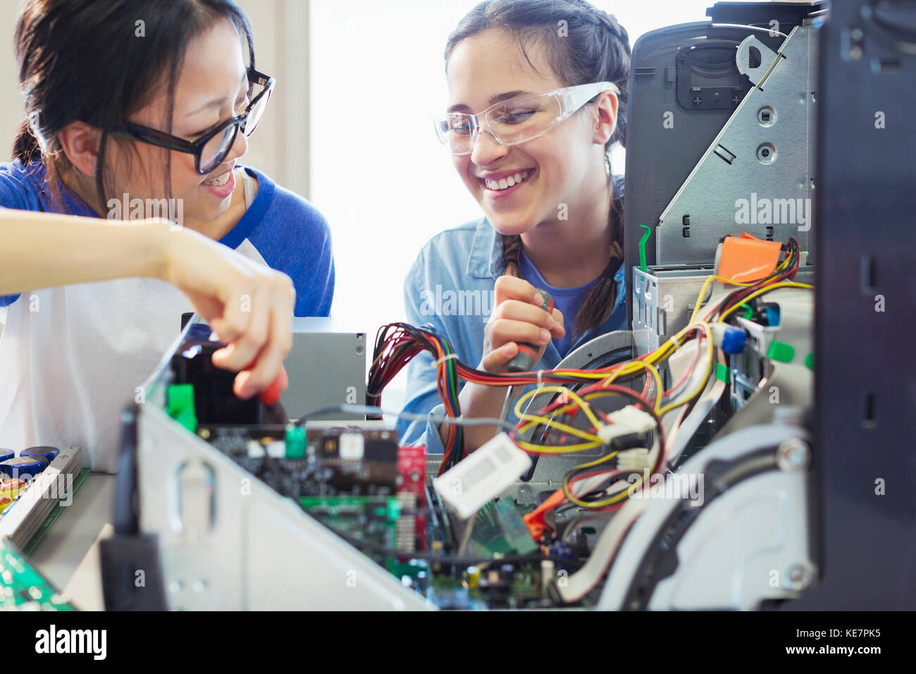 Smiling girl students assembling computer in classroom Stock Photo - Alamy