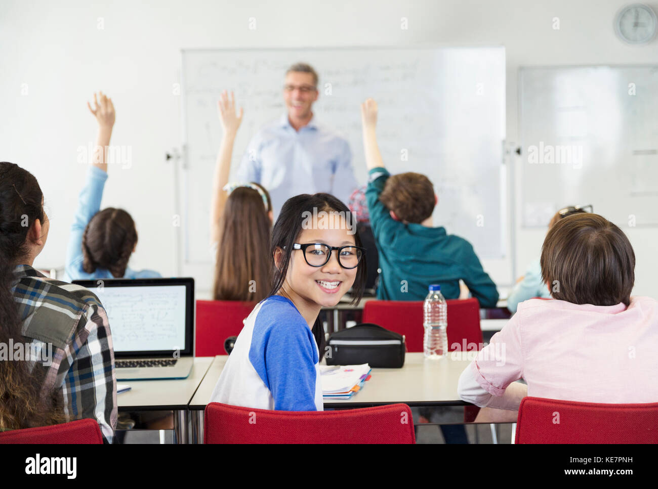 Portrait smiling girl student sitting in classroom during lesson Stock ...