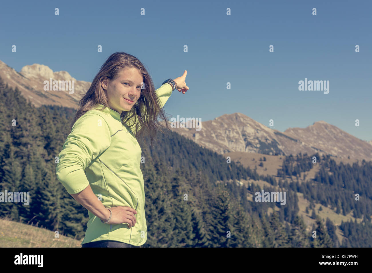 Female hiker pointing at mountain peak Stock Photo - Alamy