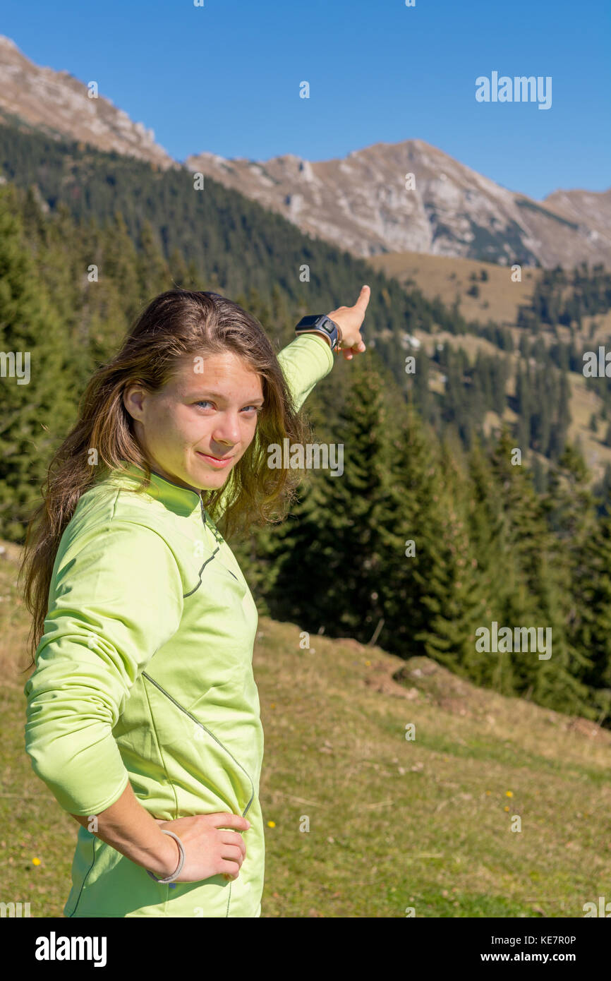 Female hiker pointing at mountain peak Stock Photo - Alamy