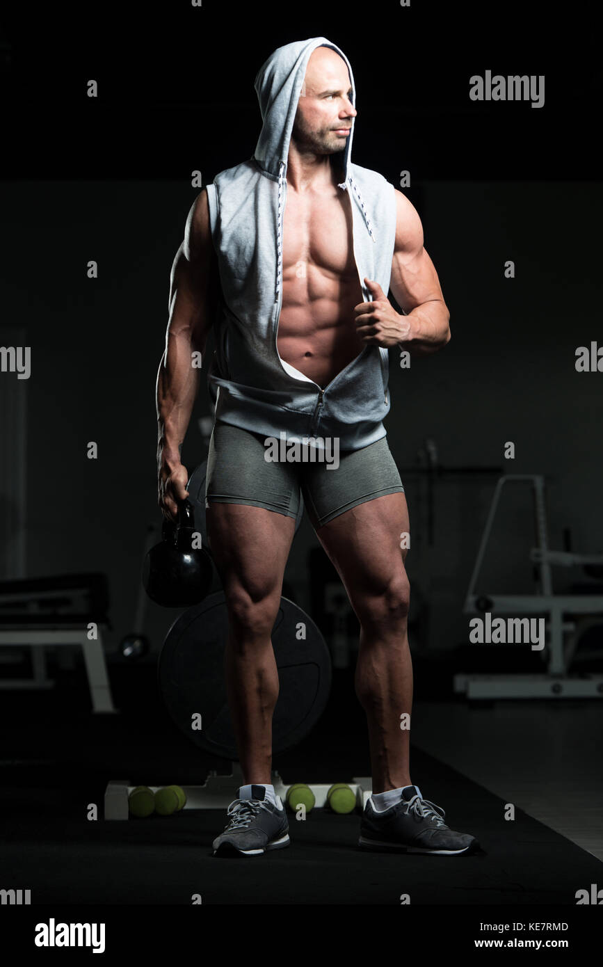 Man Exercising With Kettle Bell And Flexing Muscles - Muscular Athletic ...