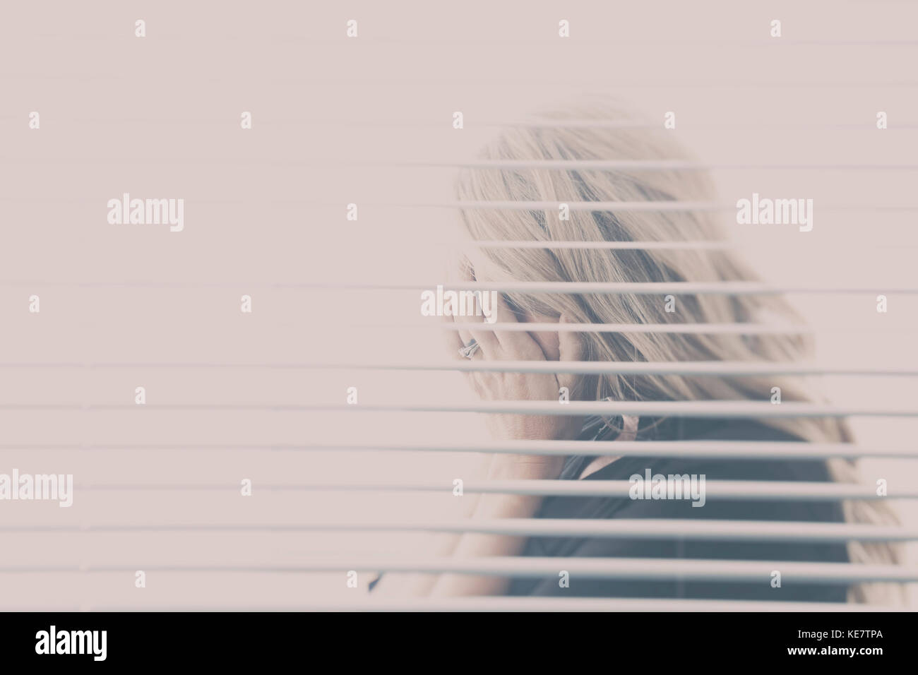 Woman With Blond Hair Seen Hiding Her Face Through A Window With Blinds ...