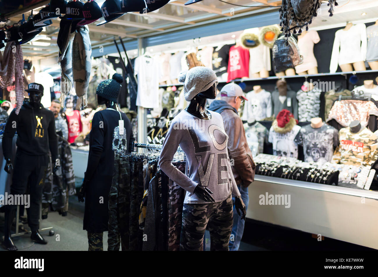 Sales stand with modern clothes at evening Stock Photo - Alamy