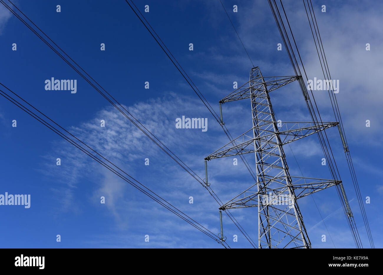 Wide angle shots of electricity pylons against a blue sky Stock Photo ...