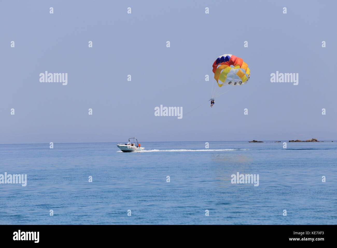 ZAKYNTHOS, GREECE - JUN 30, 2017: Parasailing - Motor boat tows a ...