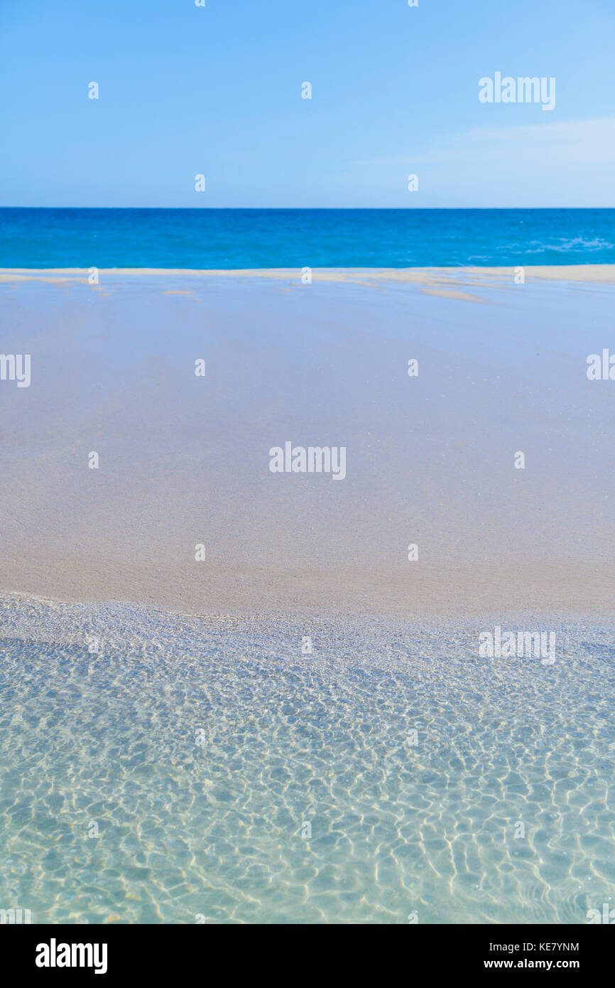 A beautiful beachscape view of a clear tide pool washed in by the ocean ...