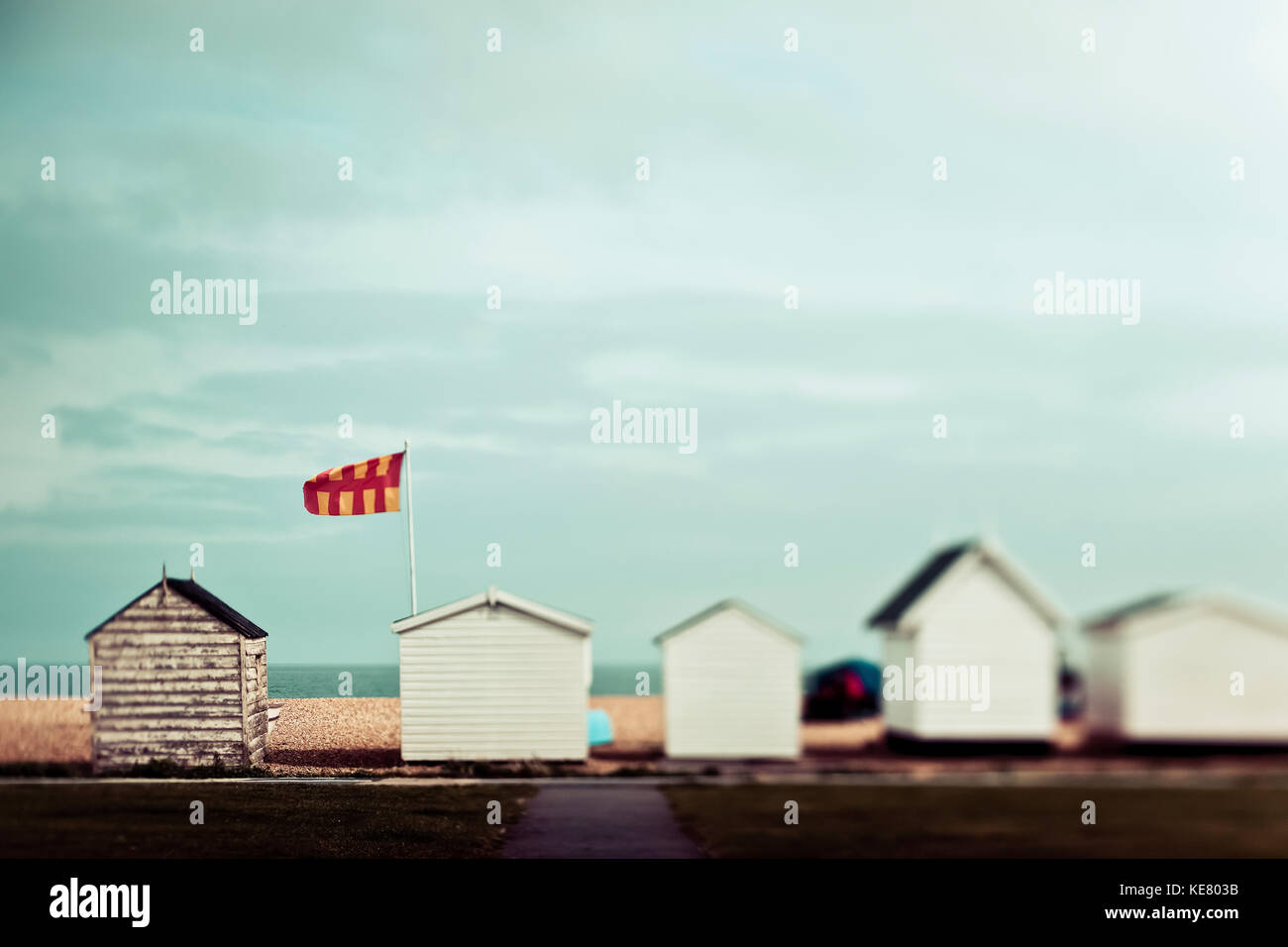 Small wooden buildings in a row on the beach with a view of the ocean ...