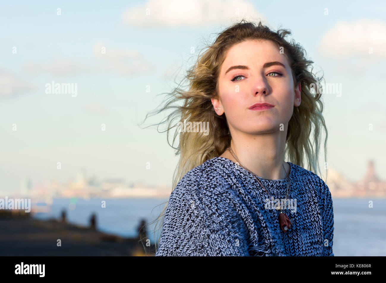 Girl looks into the distance, angled away from camera, as she poses ...
