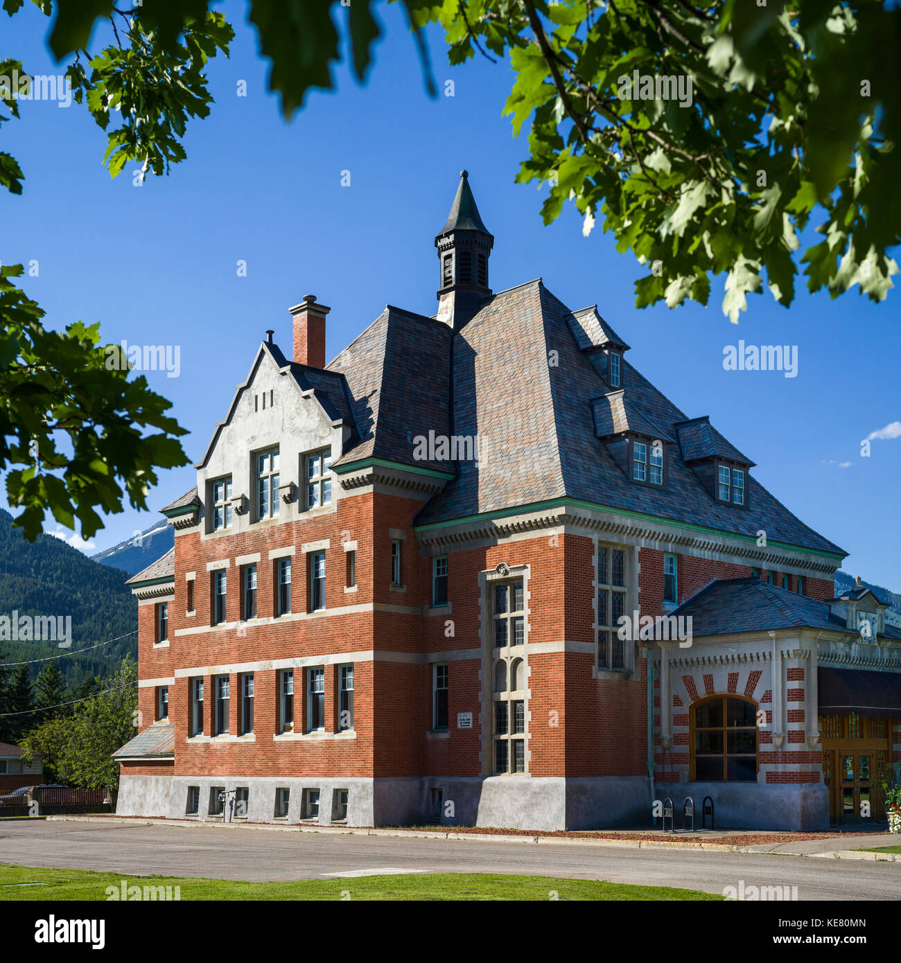 The Fernie Court House under a blue sky framed with trees; Fernie ...
