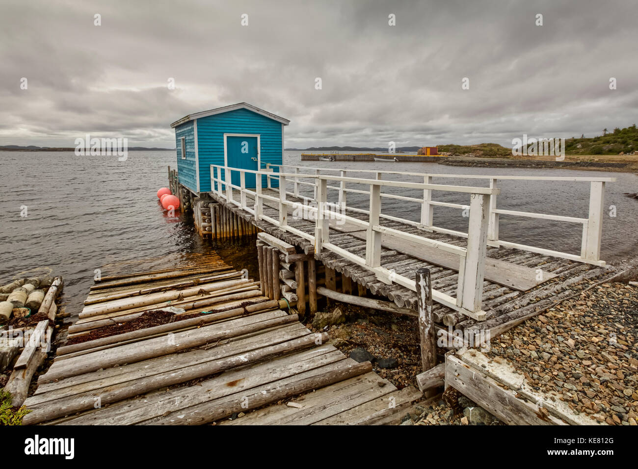 A ramp leading to a blue fishing shed and boat launch along the ...