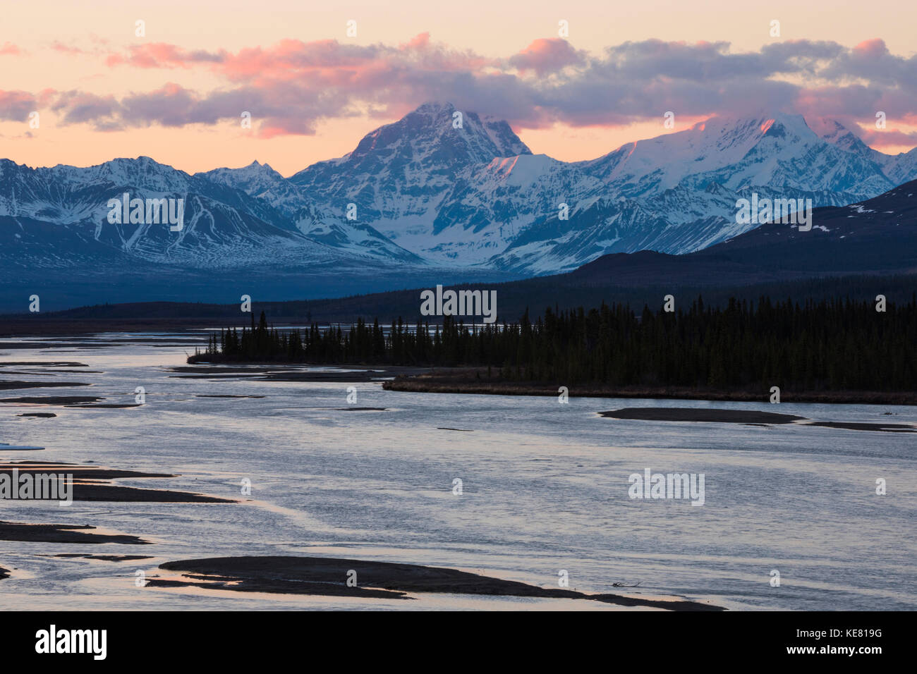 The sun sets on Mt. Deborah and Mt. Hess in the Alaska Range, viewed ...
