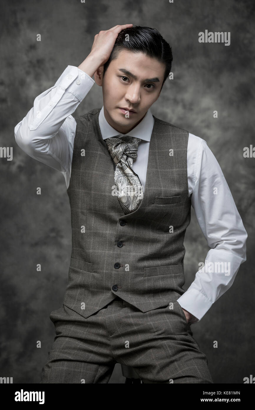 Young handsone man in retro style suit posing Stock Photo - Alamy