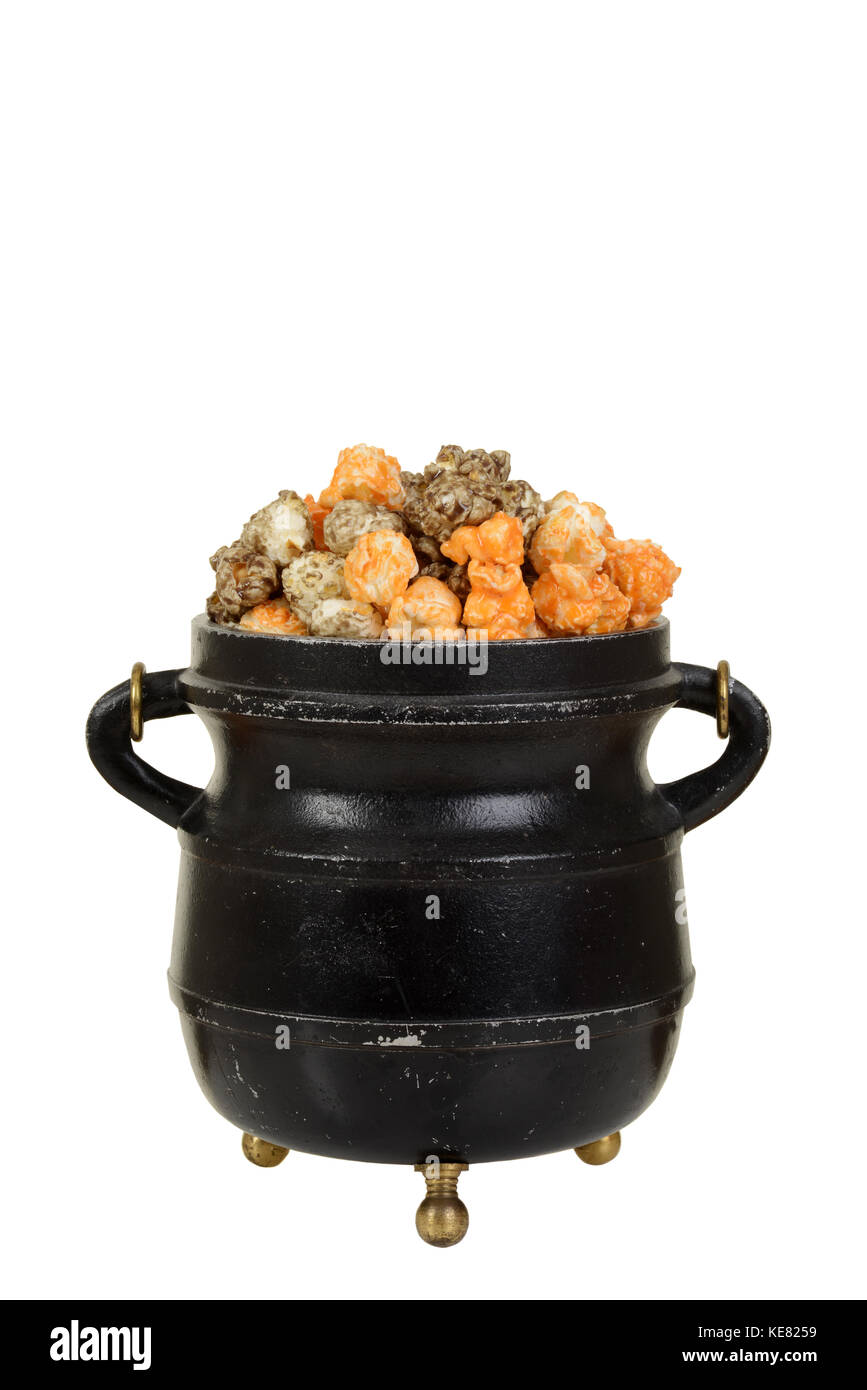 halloween orange and black licorice popcorn in old black cauldron Stock ...